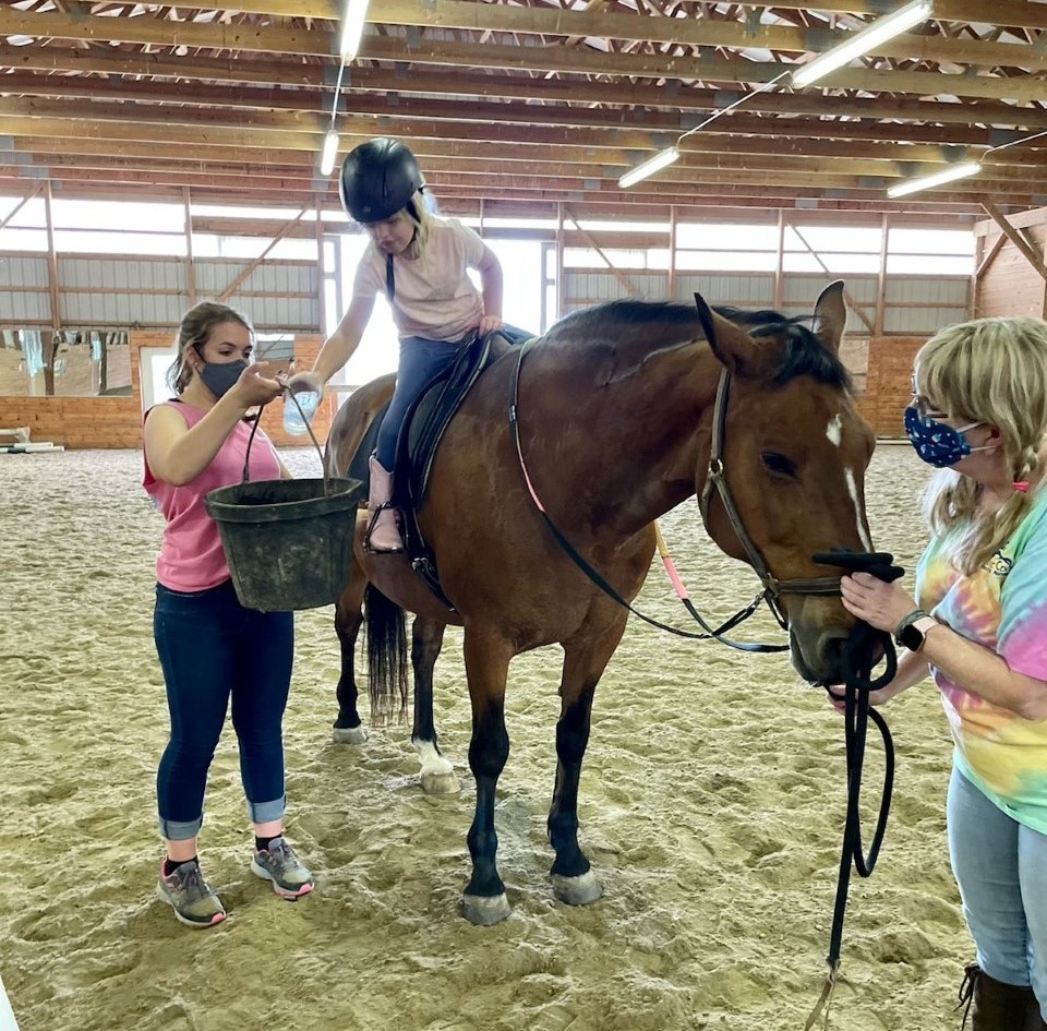 maja-about-to-pour-cup | Blue Ridge Center for Therapeutic Horsemanship